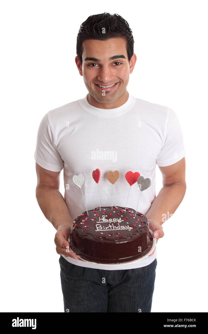 Man carrying chocolate cake decorated with hearts Stock Photo - Alamy