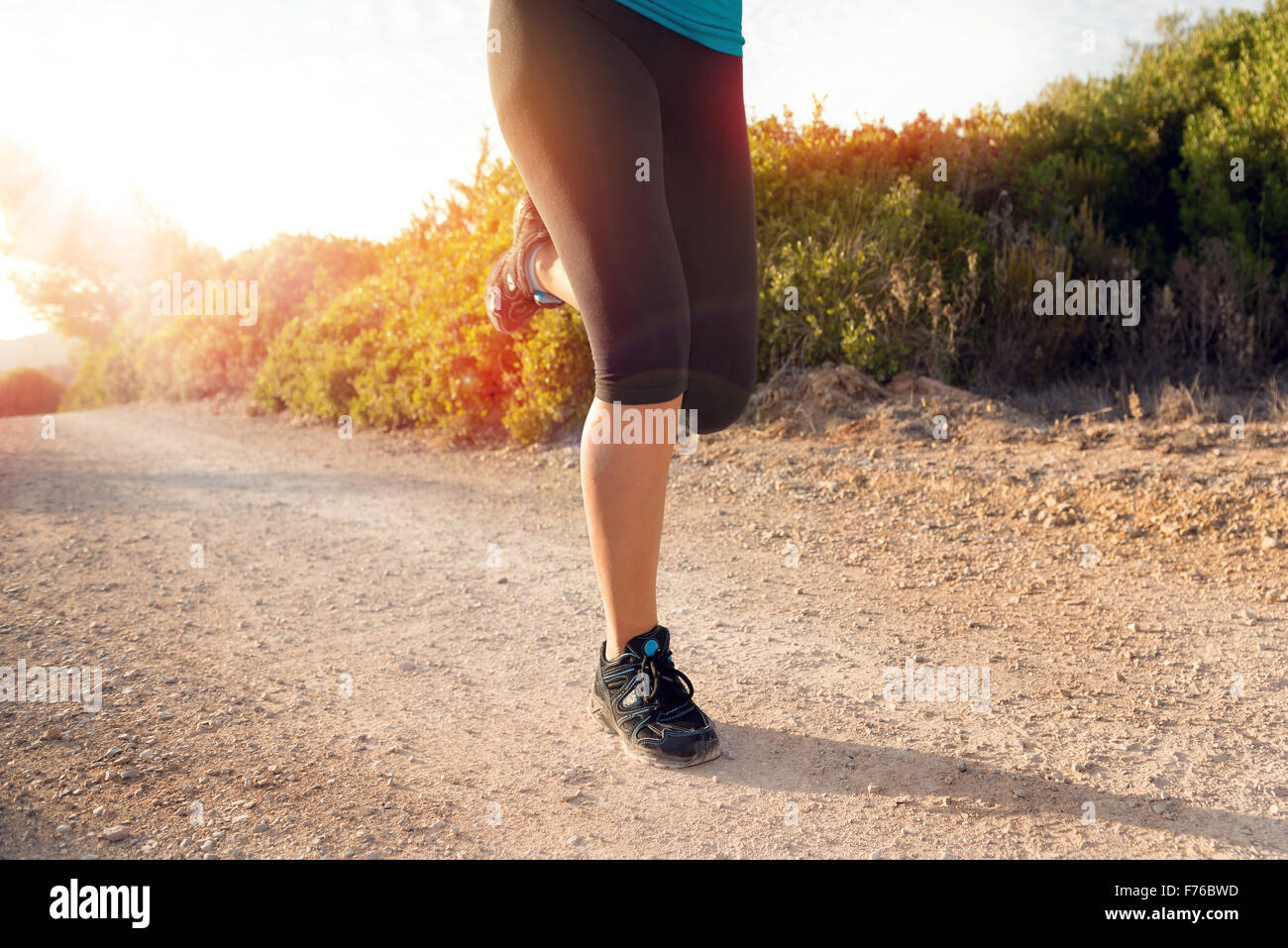 Woman's legs running outdoors at sunset hour Stock Photo - Alamy