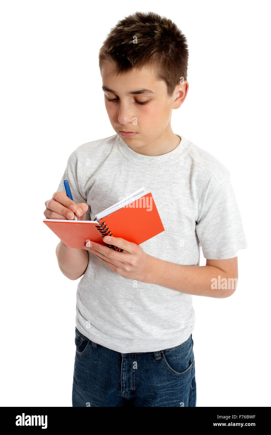 School boy writing in book Stock Photo - Alamy