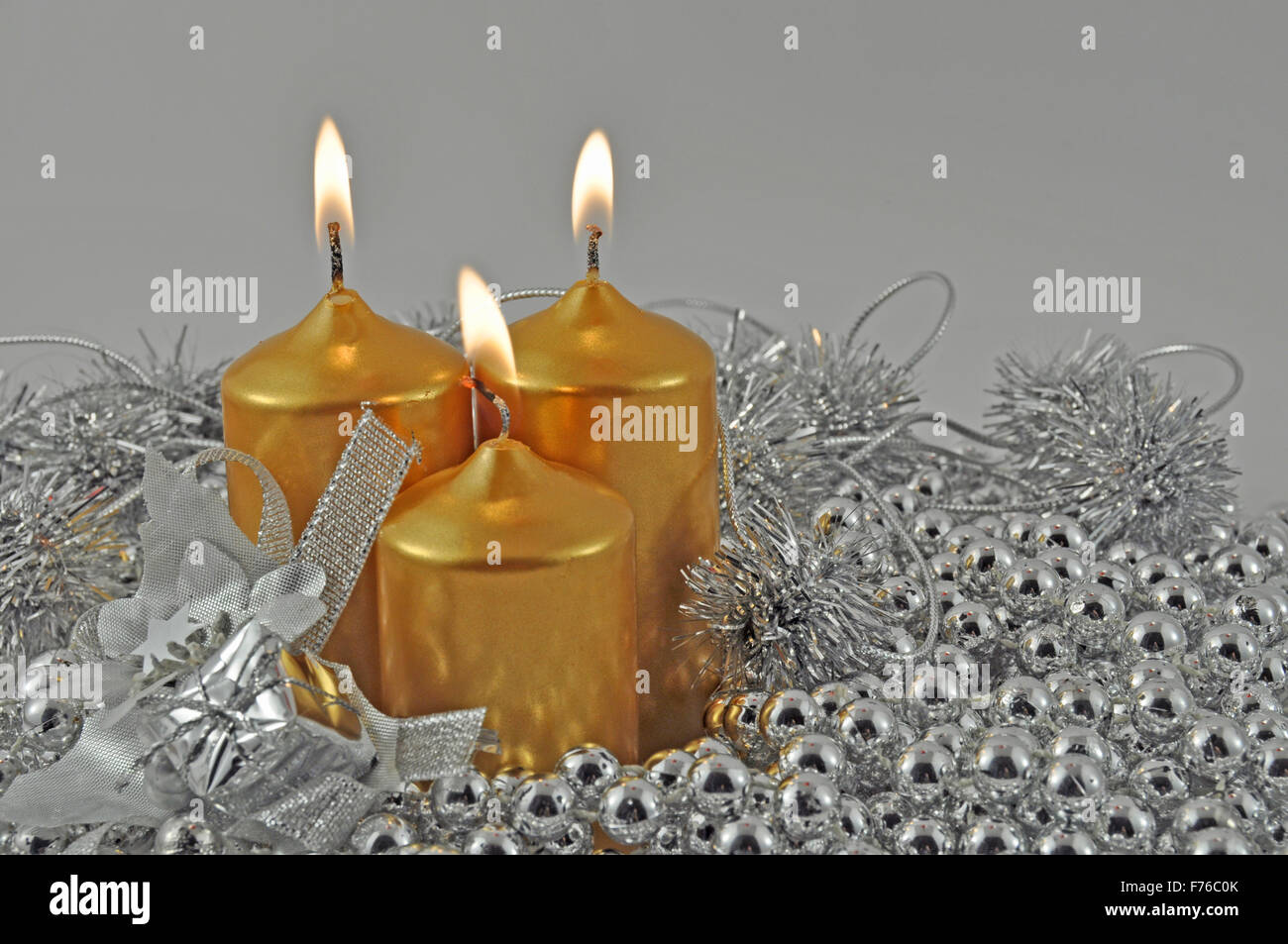 Silver burning candles Stock Photo - Alamy