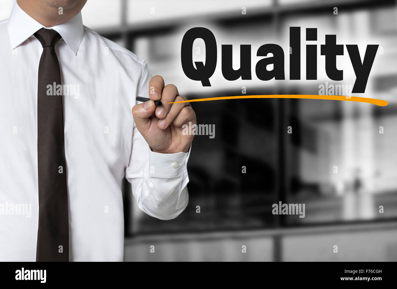 Quality is written by businessman background concept Stock Photo - Alamy