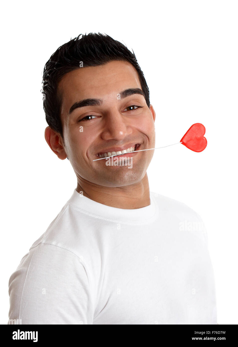 Flirtatious man holding a love heart between his teeth Stock Photo - Alamy