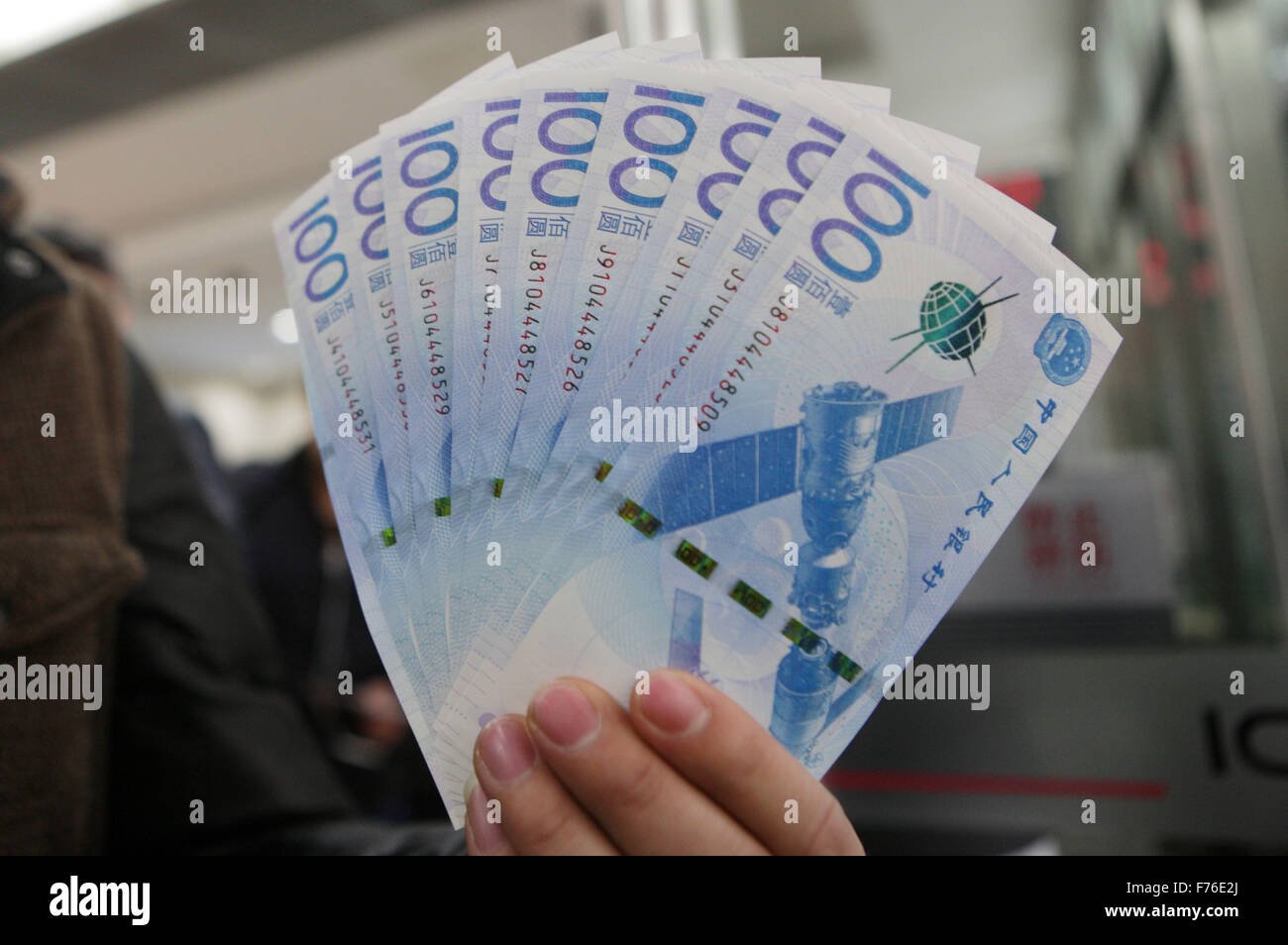 Beijing, China. 26th Nov, 2015. A resident shows commemorative notes at ...