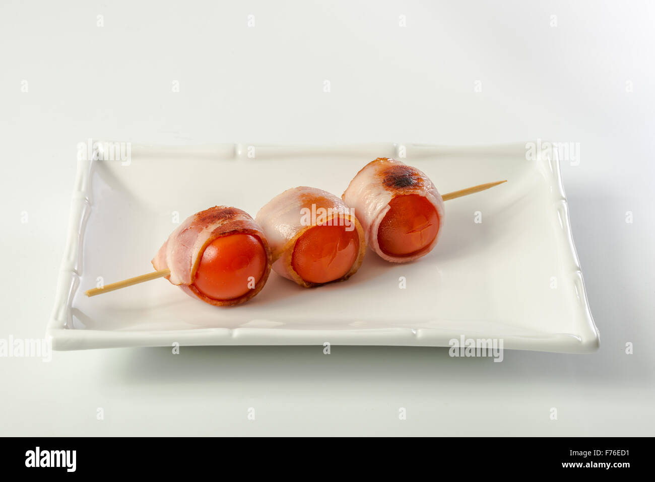 Bacon wrapped Cherry Tomatoes on stick Stock Photo - Alamy