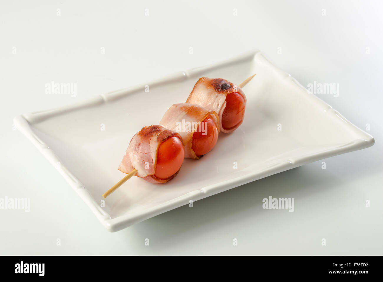 Bacon wrapped Cherry Tomatoes on stick Stock Photo - Alamy
