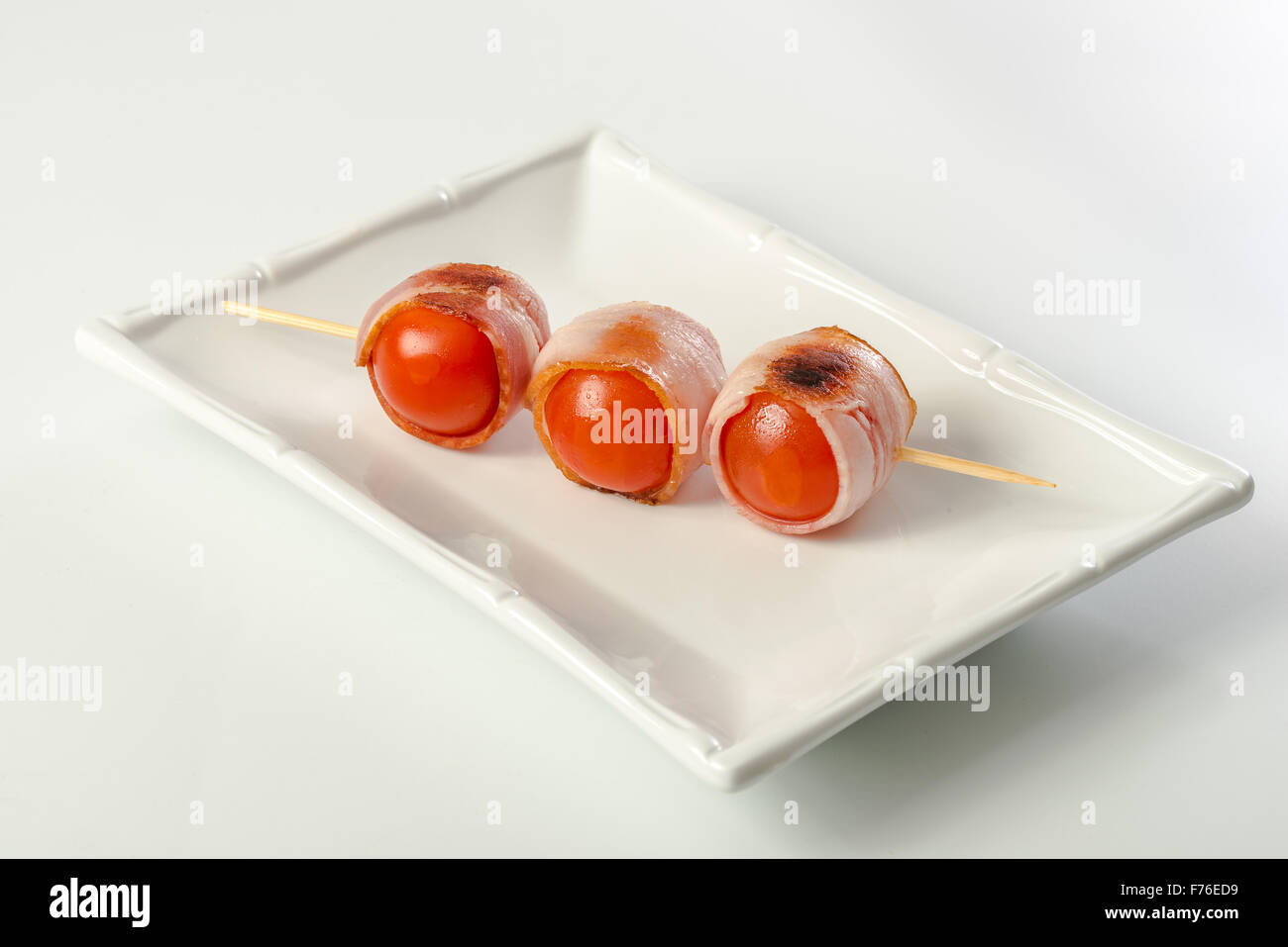 Bacon wrapped Cherry Tomatoes on stick Stock Photo - Alamy