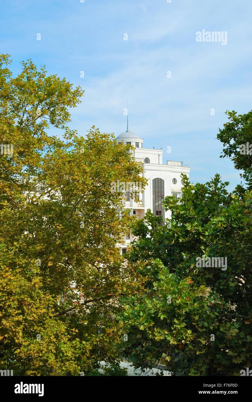 Building behind trees Stock Photo - Alamy