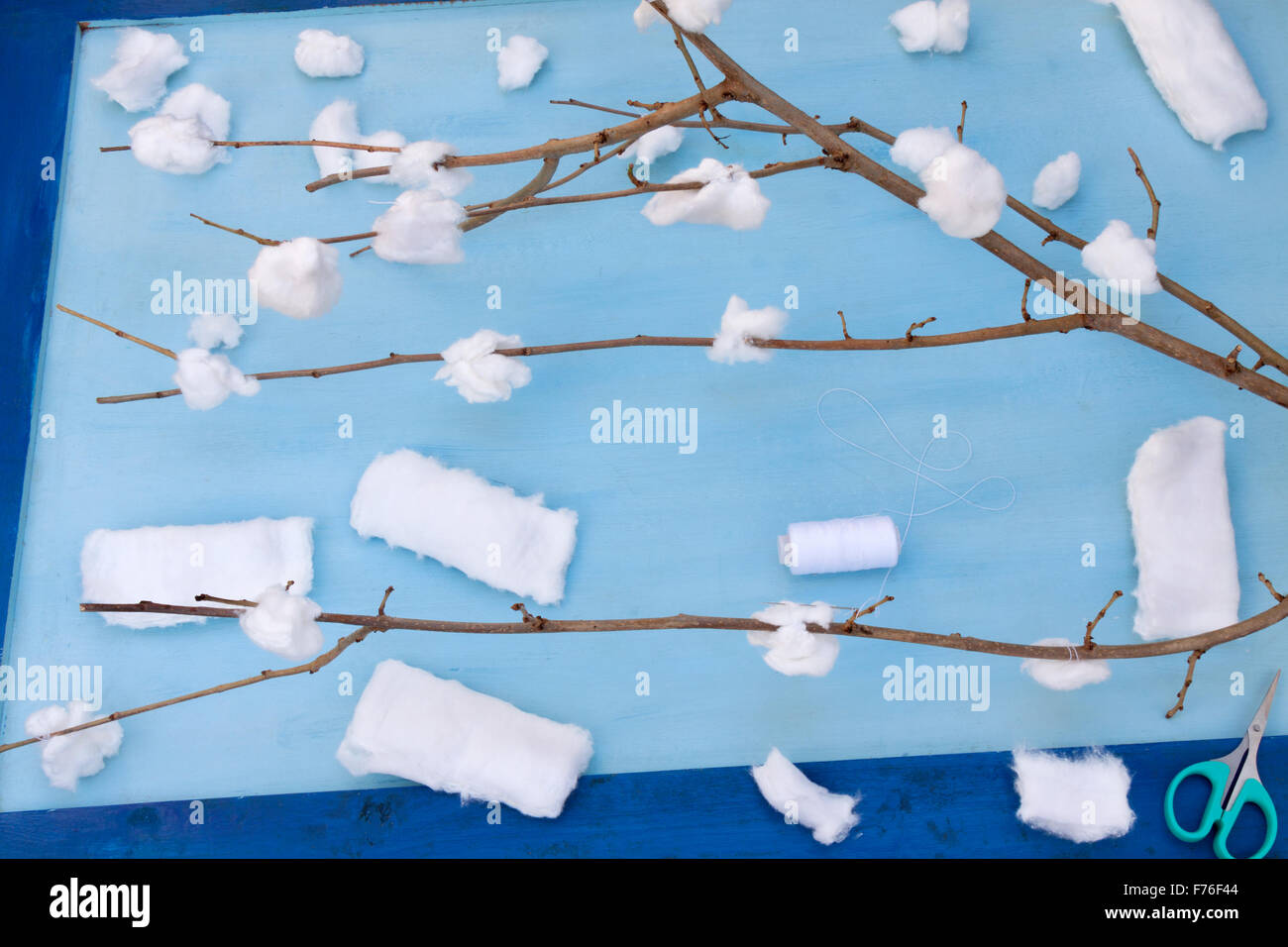a vertical overhead view of a xmas craft cotton decorations on a branch ...