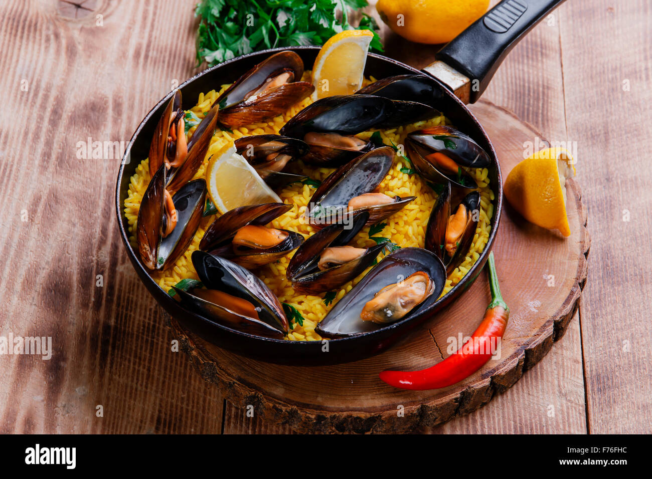 mussel paella rice in a frying pan Stock Photo - Alamy
