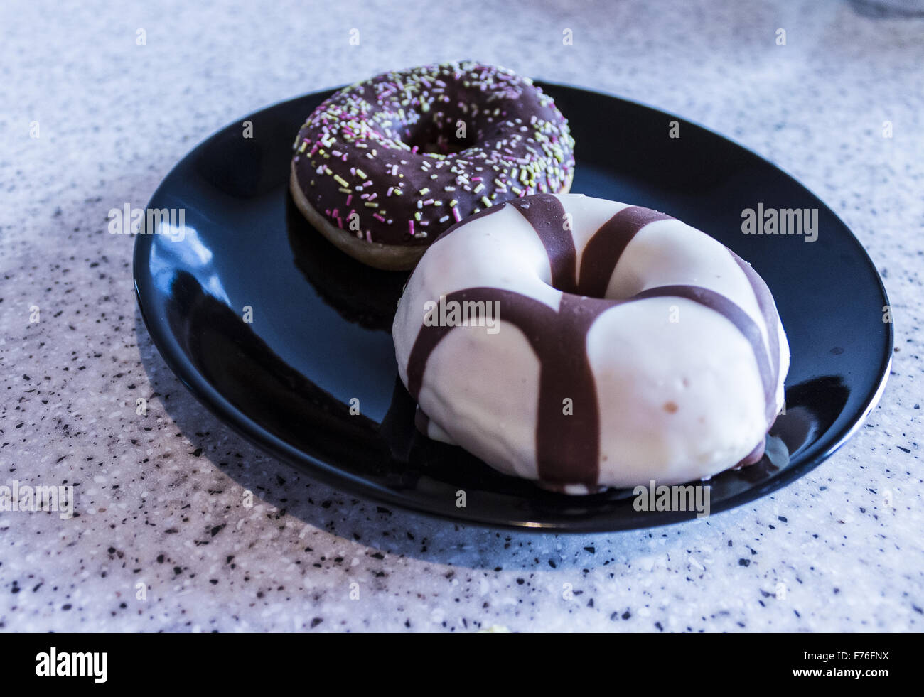 Delicious doughnuts on a plate Stock Photo - Alamy