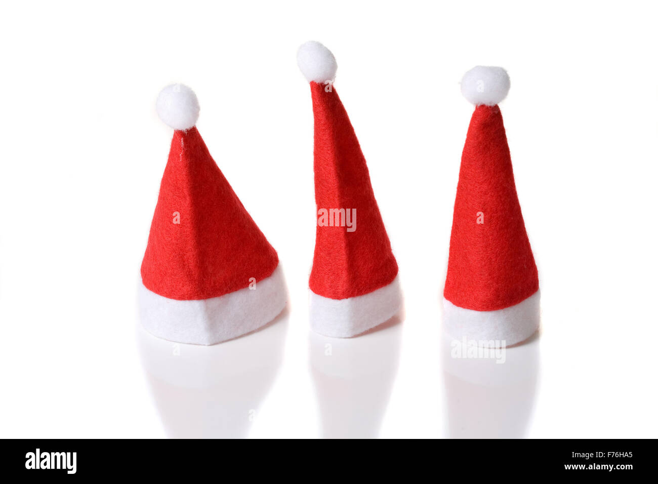 Three small santa hats Stock Photo - Alamy