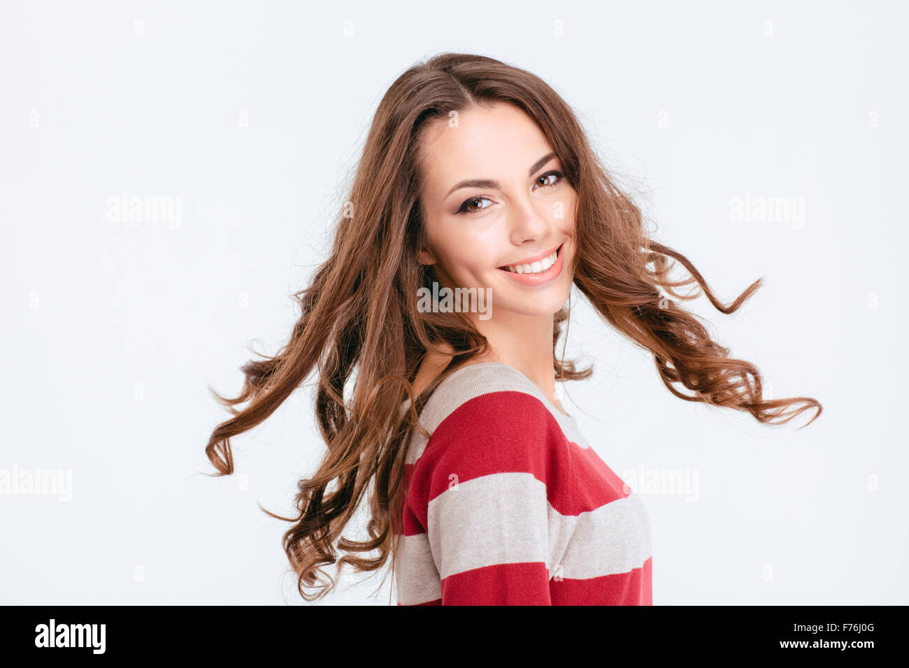 Portrait of a smiling pretty woman turning around and looking at camera ...