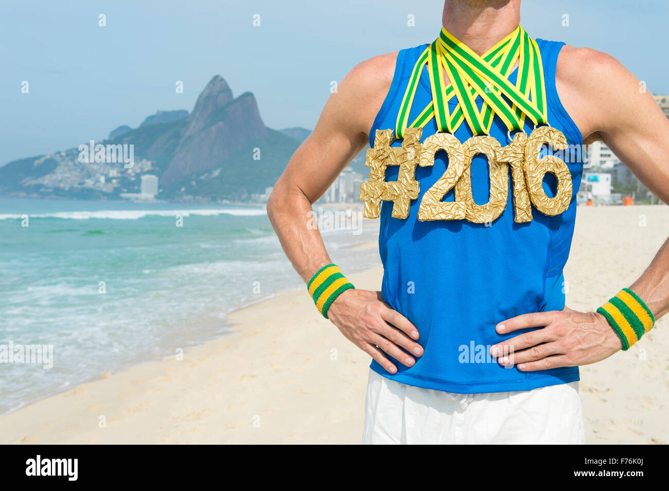 Athlete with hashtag 2016 gold medals standing on the beach in Rio de ...