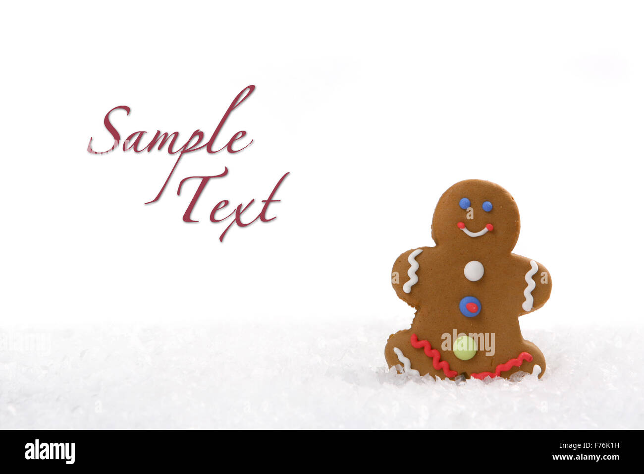 One Gingerbread Man Sitting in the Snow Stock Photo - Alamy