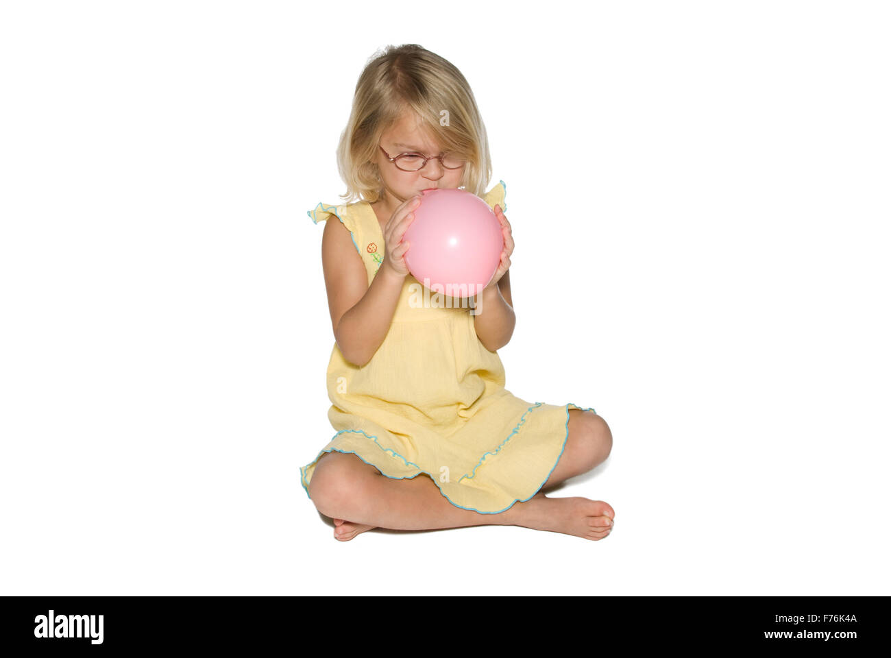 Girl Inflating Balloon Stock Photo - Alamy