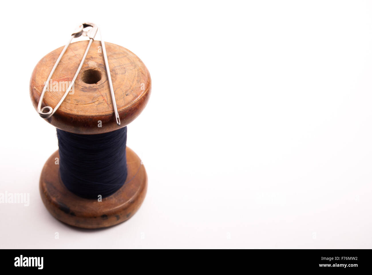 spool of thread with needle Stock Photo - Alamy