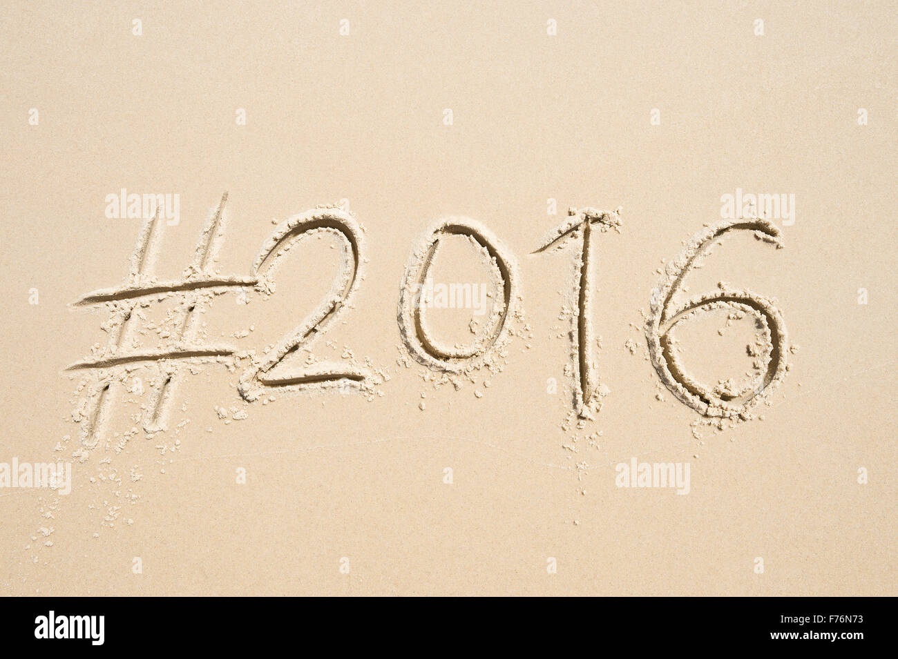 Hashtag social media message for 2016 written in smooth sand on the ...