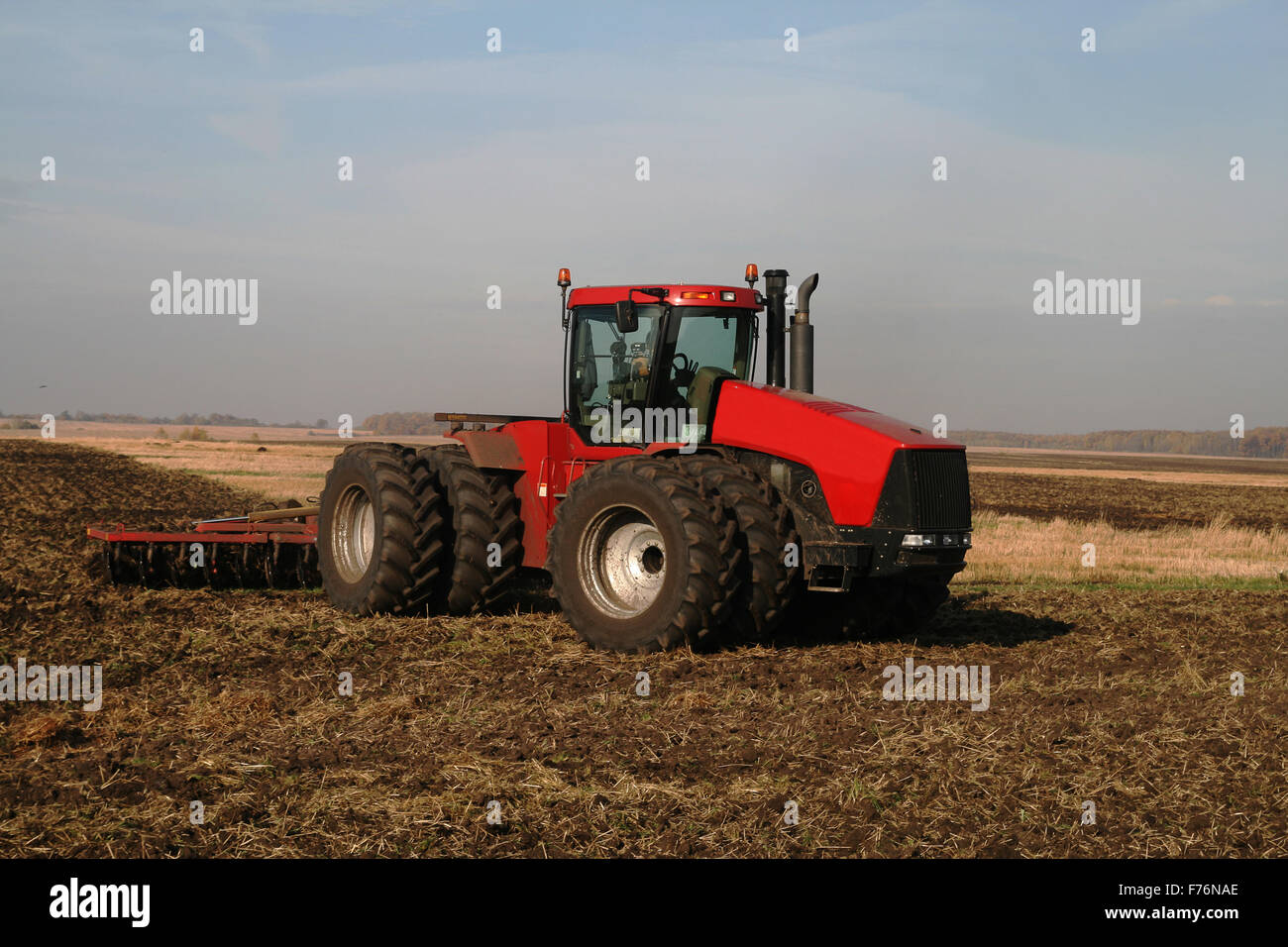 Tractor and harrow Stock Photo - Alamy