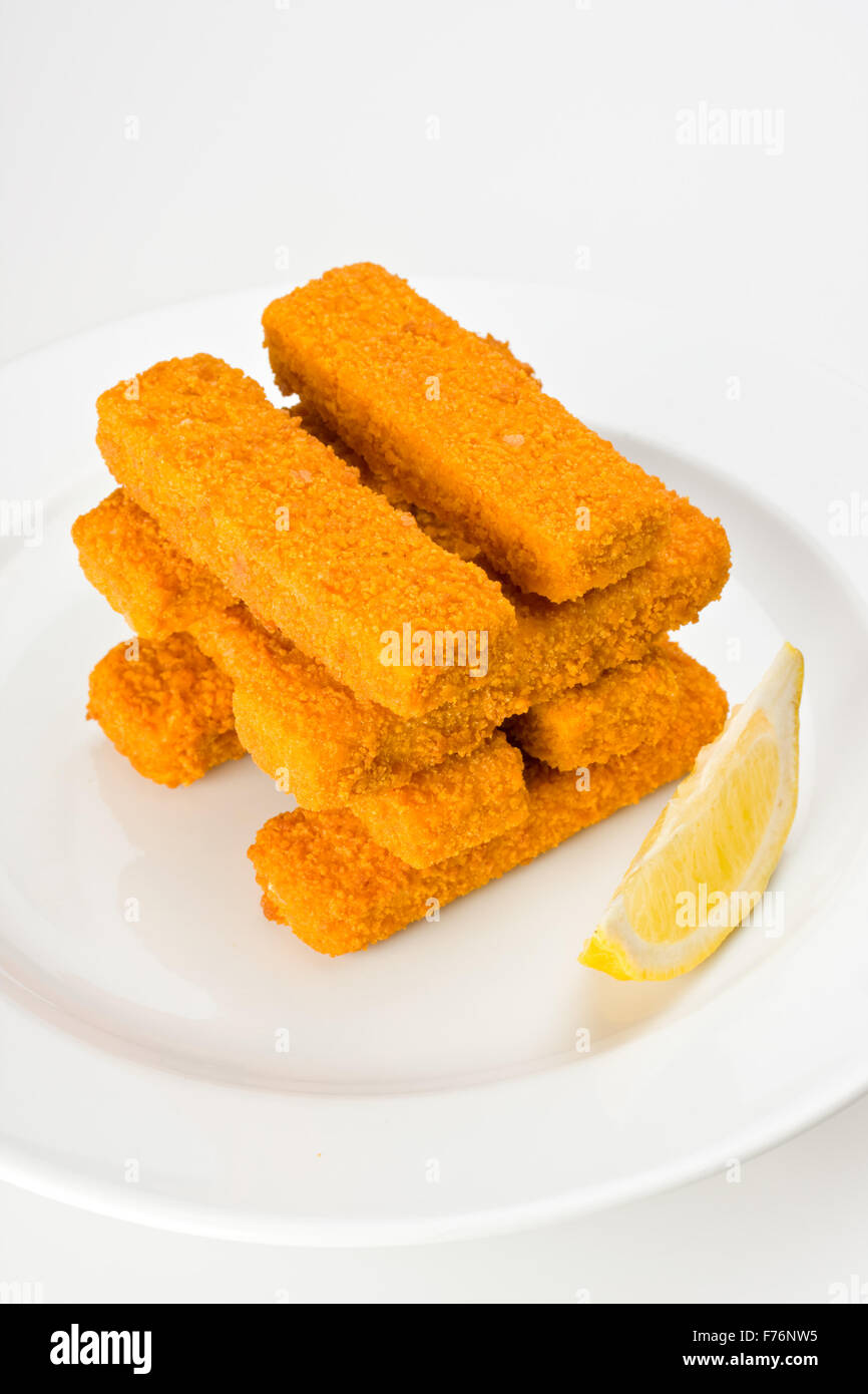 eight fish fingers on a white plate Stock Photo - Alamy