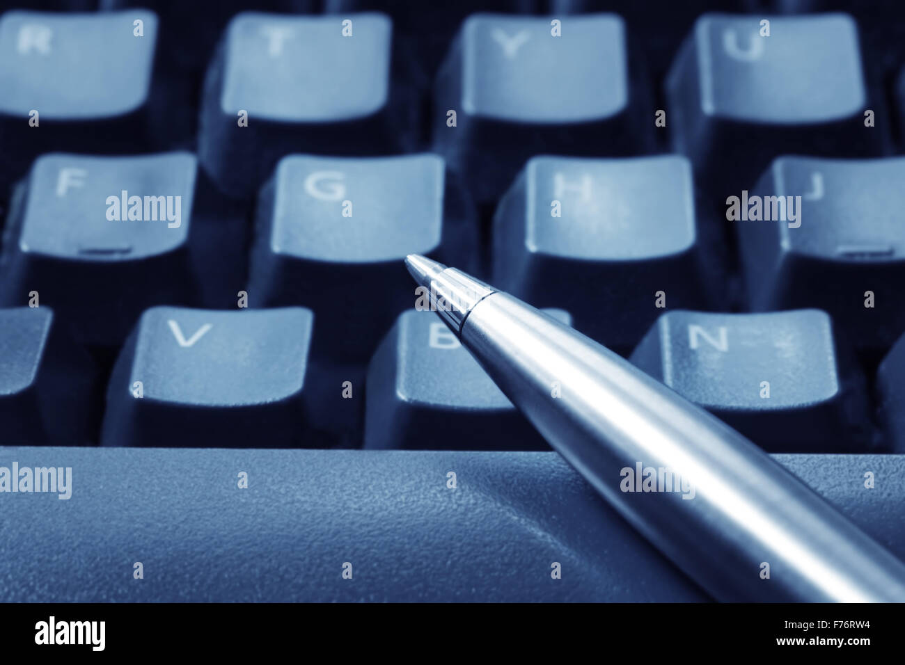 Pen on Keyboard Stock Photo - Alamy