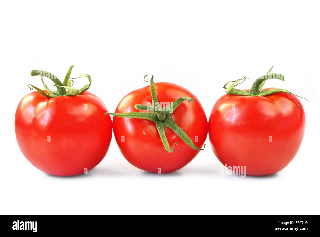 Vine ripened tomatoes on white background hi-res stock photography and ...