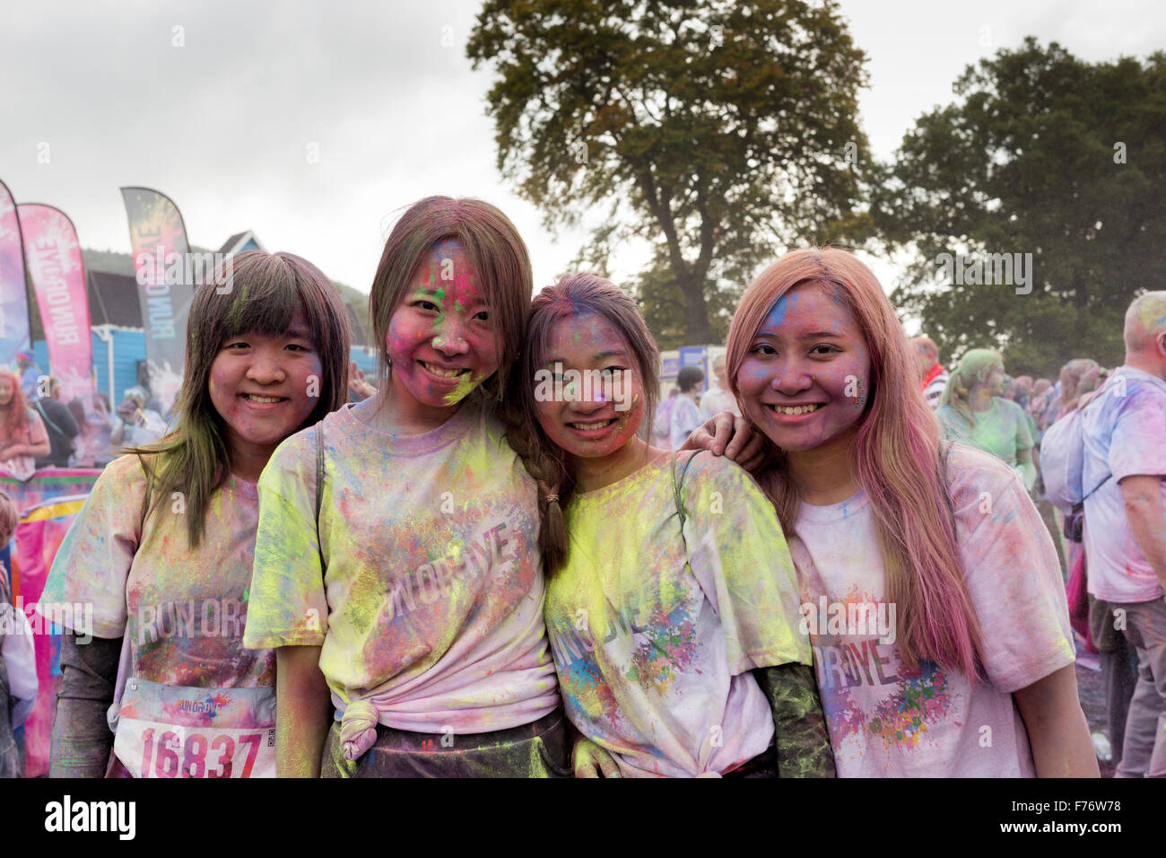 Group of friend pose for camera after being covered in colored dye at ...