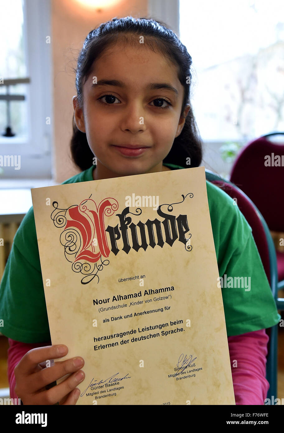 Golzow, Germany. 26th Nov, 2015. Nine-year old Nour from Syria holds up ...