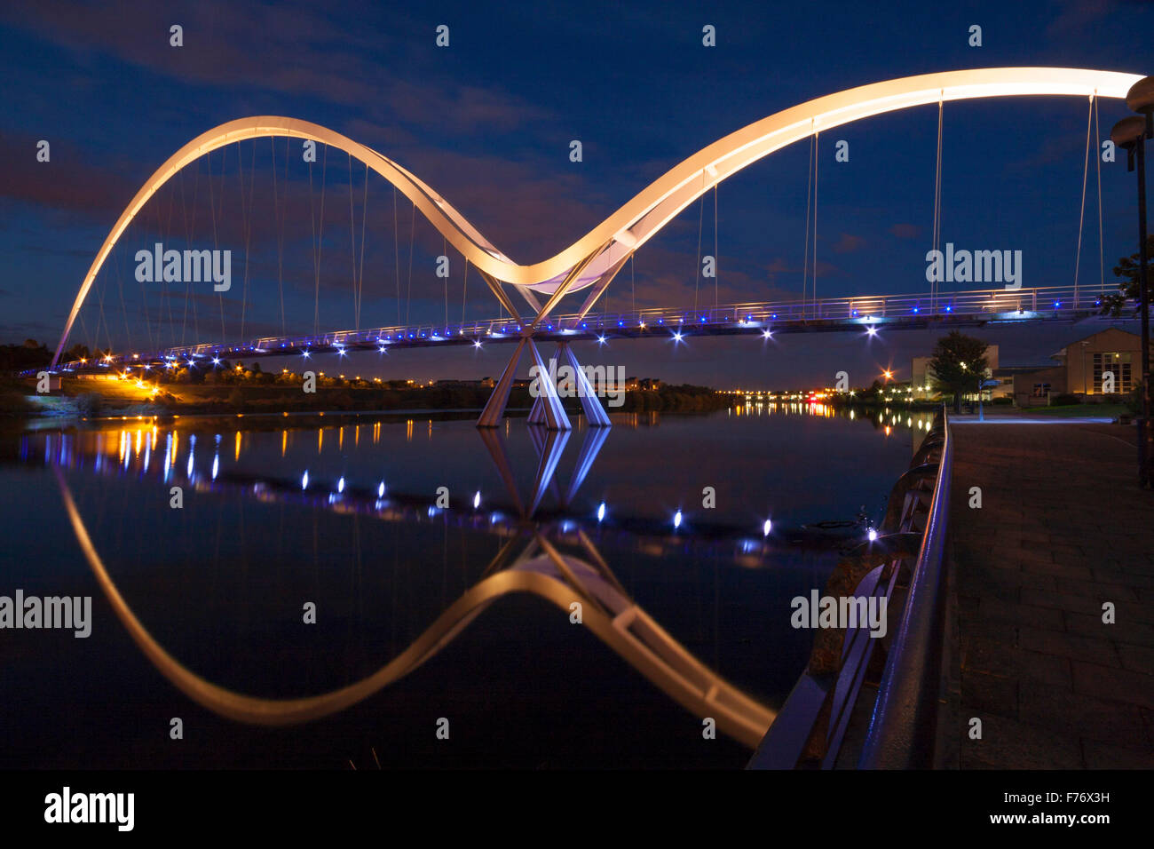 Night time view of the illuminated Infinity Bridge spanning the river ...
