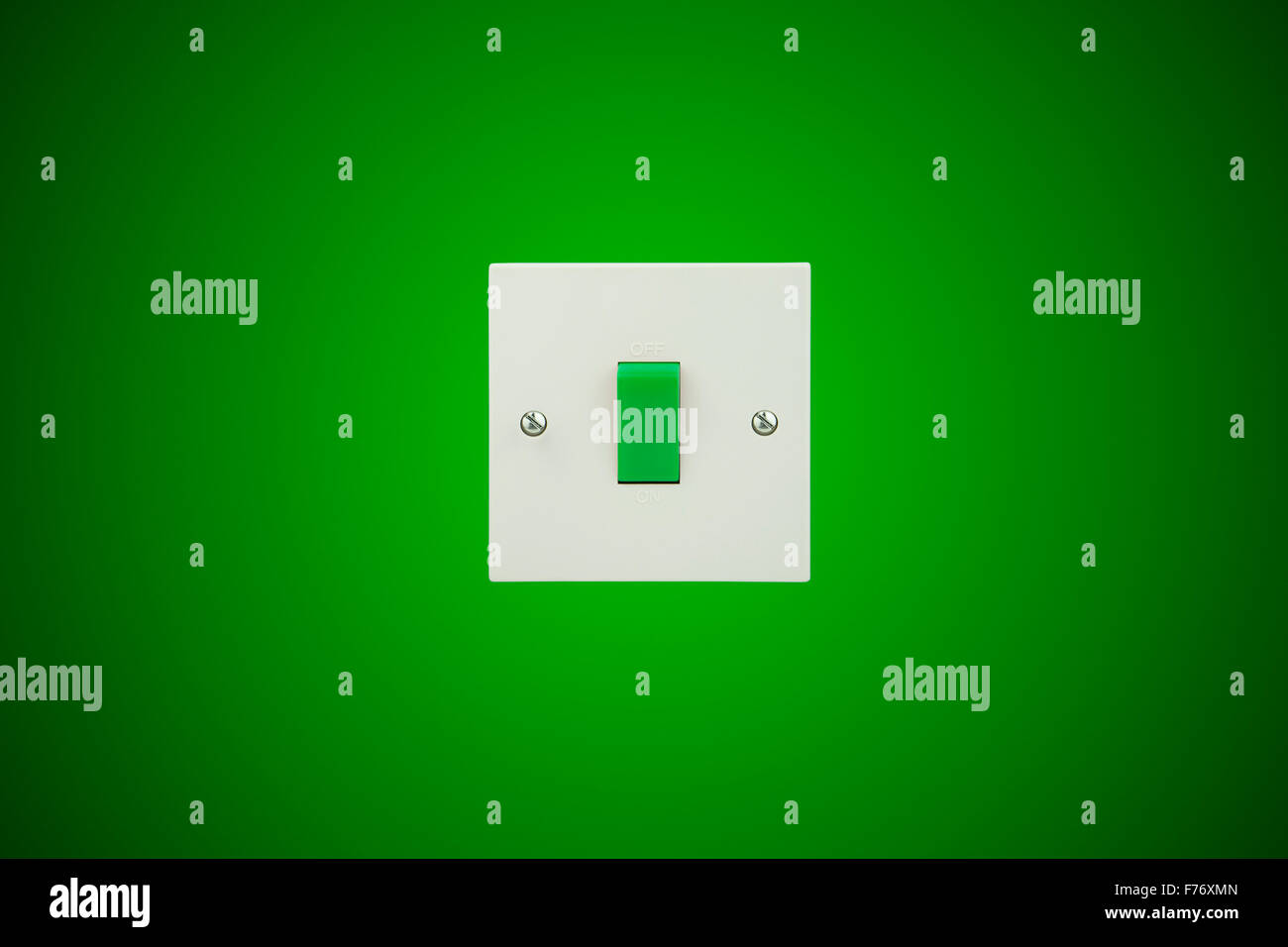 Green Switch on a white socket and a green background wall Stock Photo ...