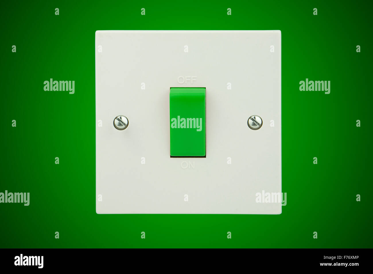 Green Switch on a white socket and a green background wall Stock Photo ...