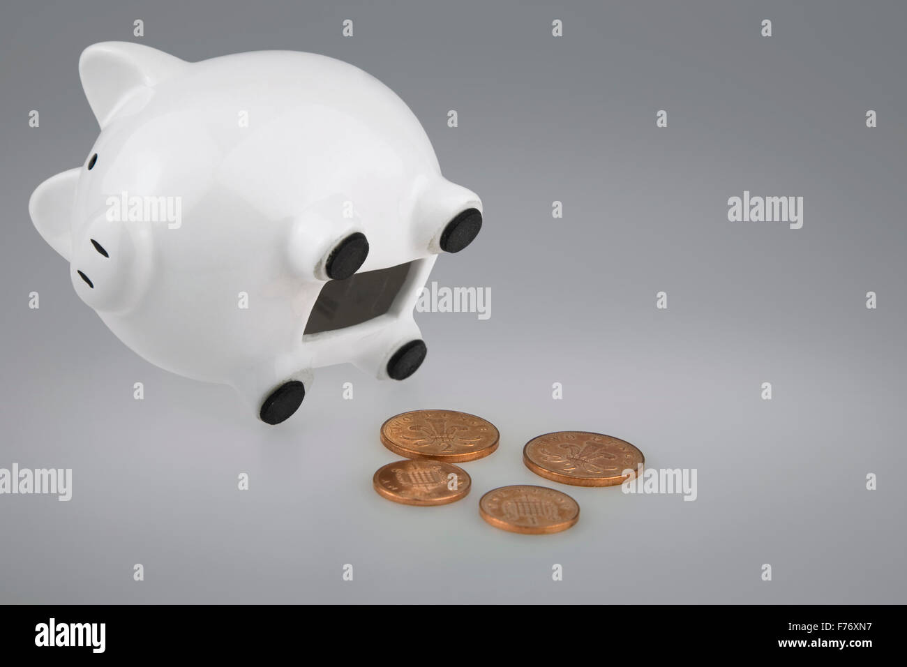 White Piggy bank on its side with Coin slot open with british tw Stock ...
