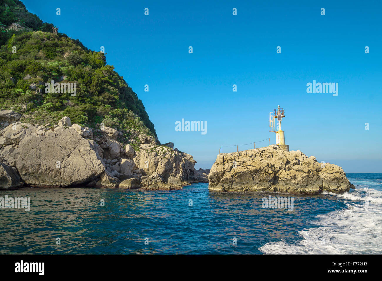 Lighthouse on the coastal rocks at the Mediterranean Sea in Capri ...