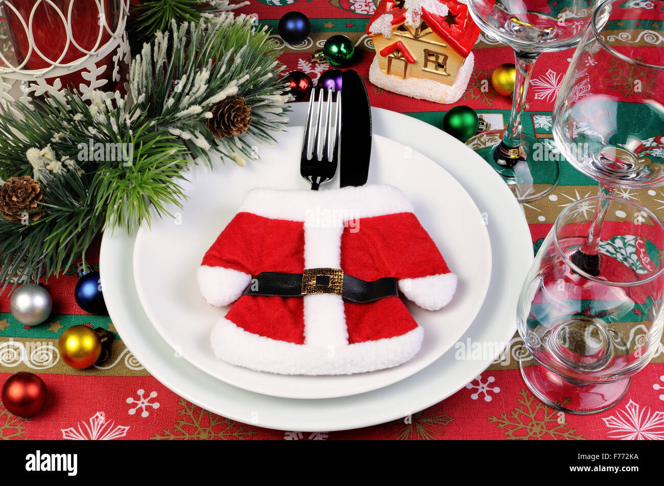 Fragment of the Christmas table serving coat of Santa Claus with ...