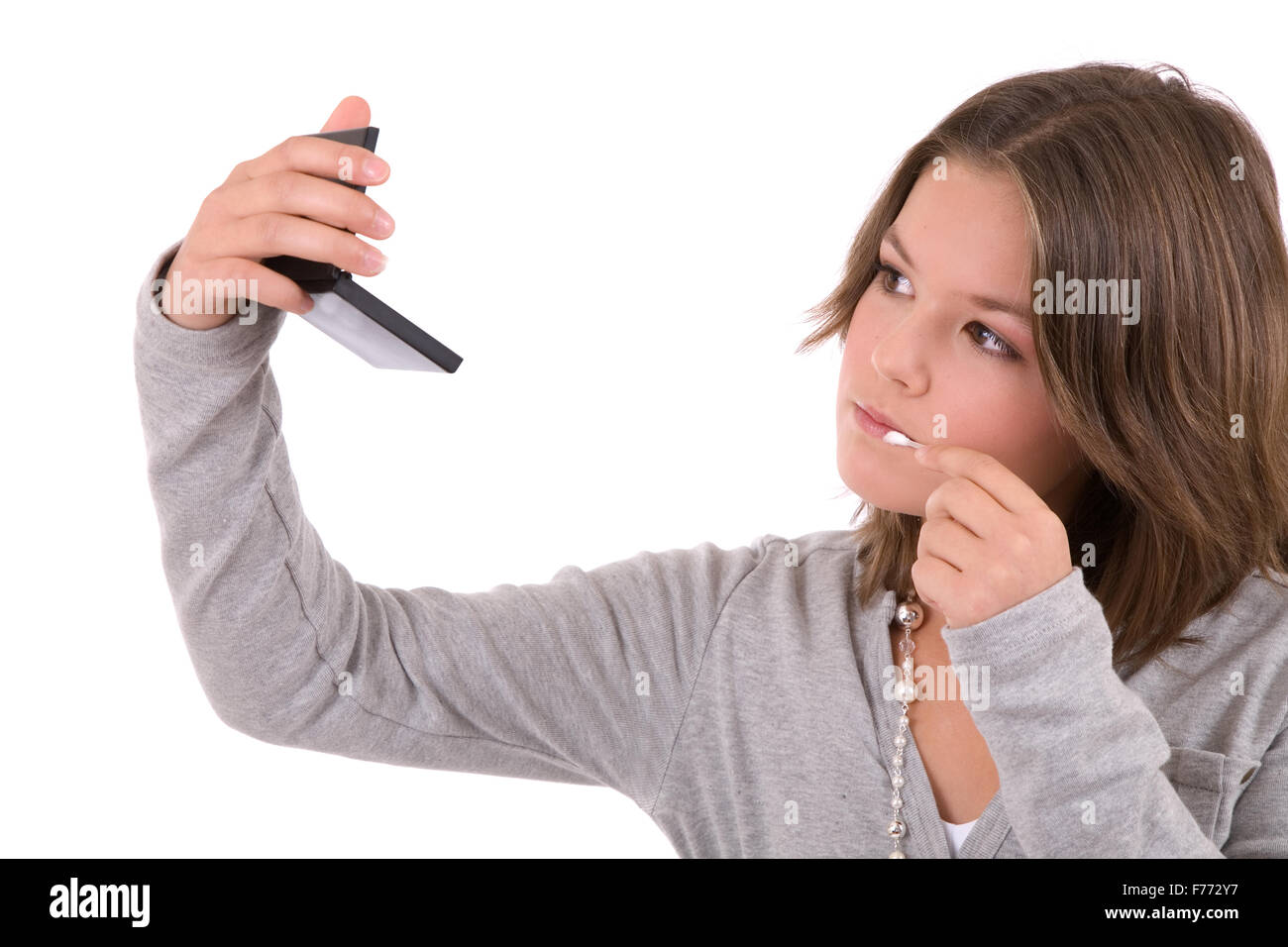 Checking her makeup Stock Photo - Alamy
