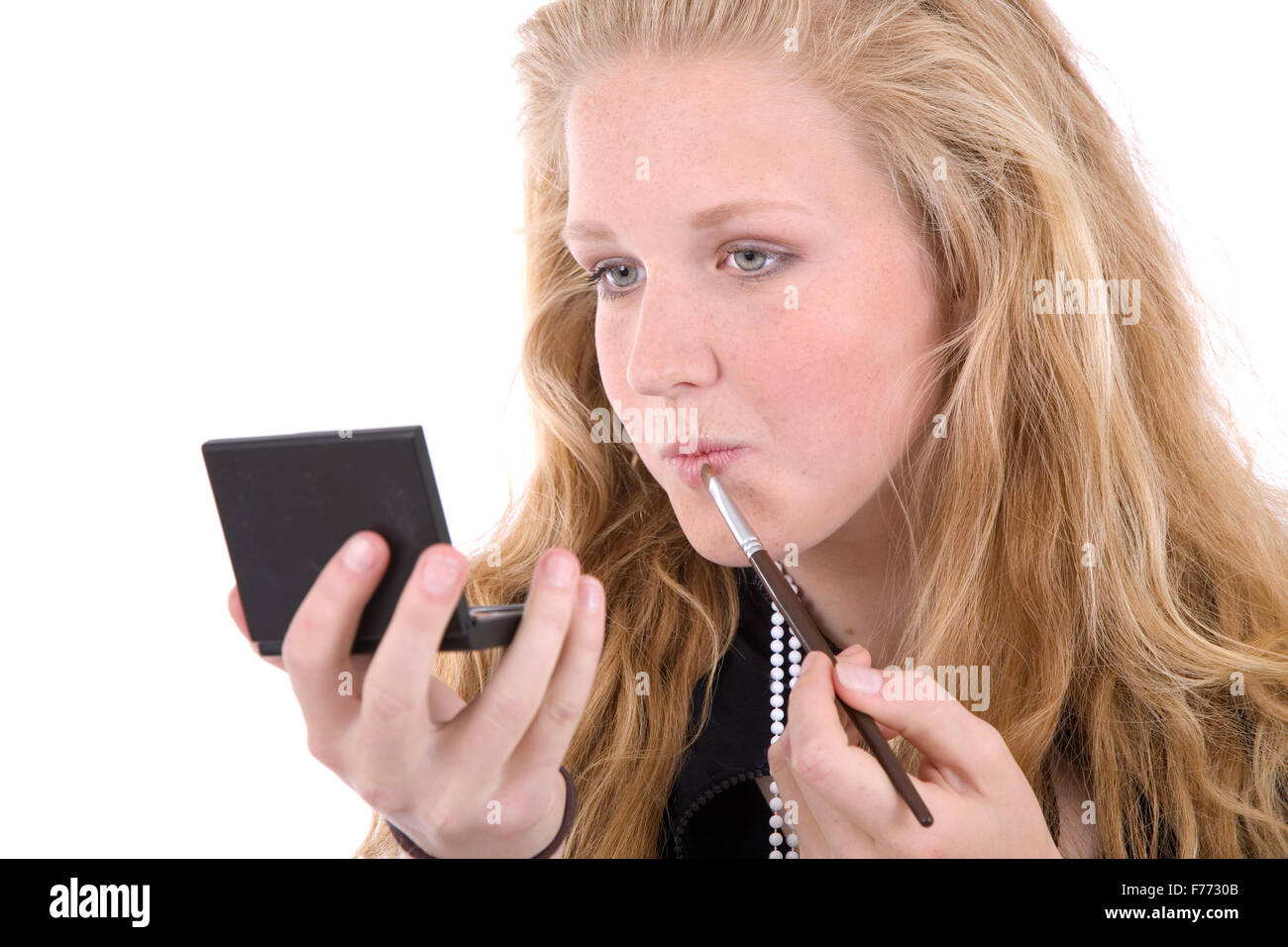 Checking her lipstick Stock Photo - Alamy