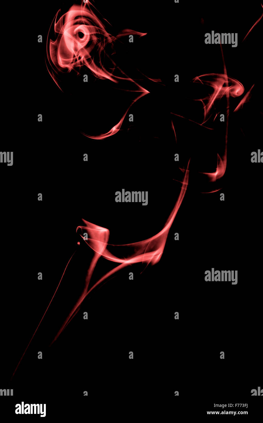 Alien face in red smoke Stock Photo - Alamy