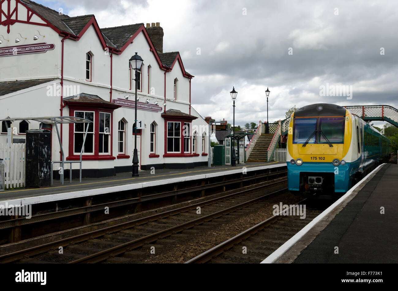 Train arriving at Llanfairpwllgwyngyllgogerychwyrndrobwllllantysiliogogogoch Station on Anglesea ...