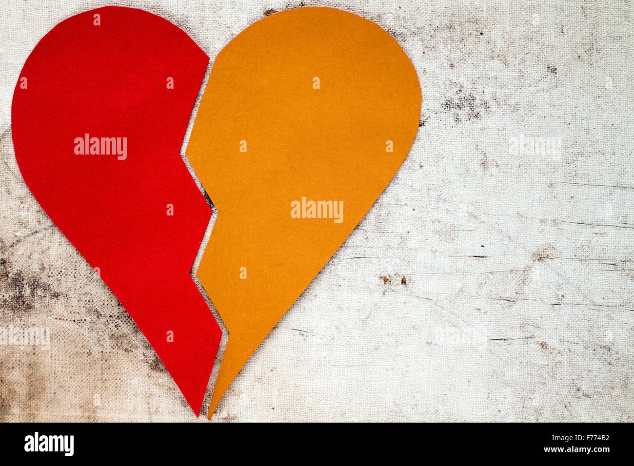 Red and yellow parts of the broken heart made of paper Stock Photo - Alamy