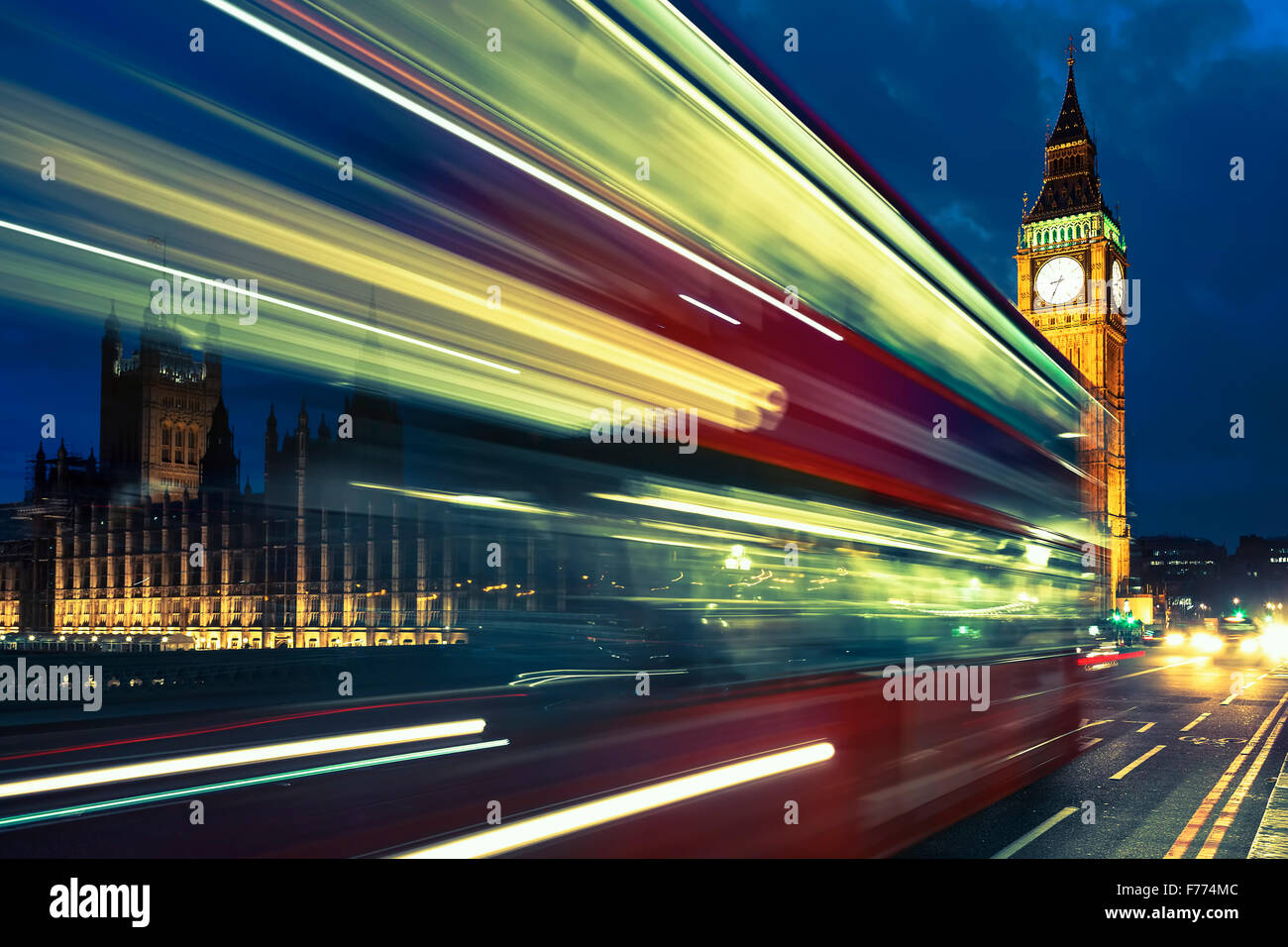 Bus crossing the bridge in front of Big Ben by night, London Stock ...