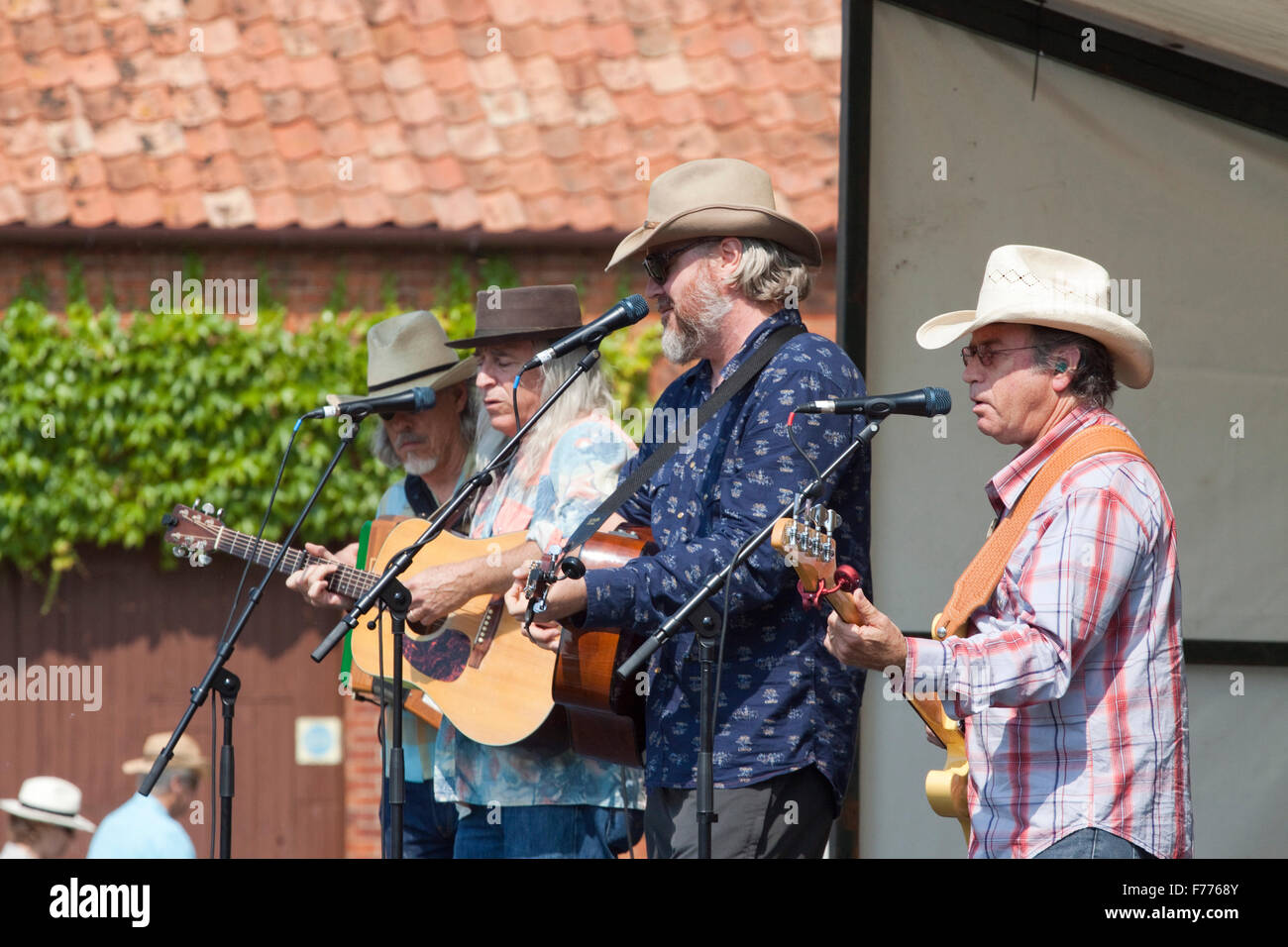 Four country musicians on an outside stage Stock Photo - Alamy