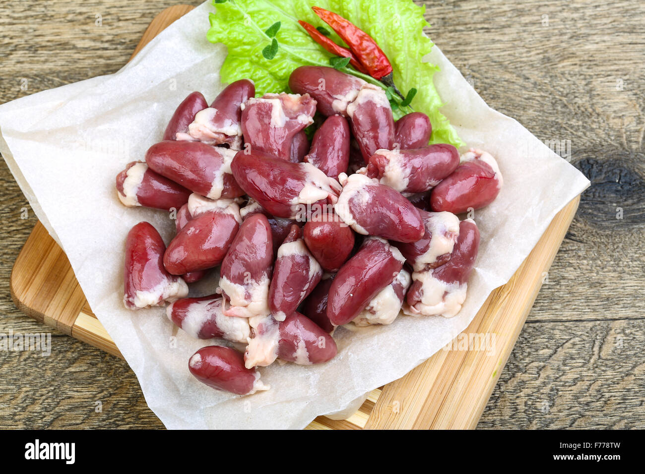 Raw chicken hearts ready for cooking on the wood background Stock Photo ...