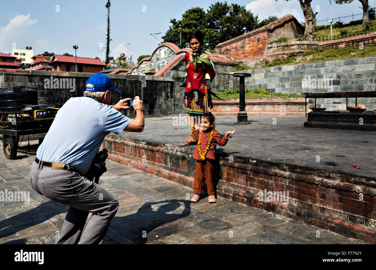 a foreigner tourist photographs a child at Pashupatinath, child with ...