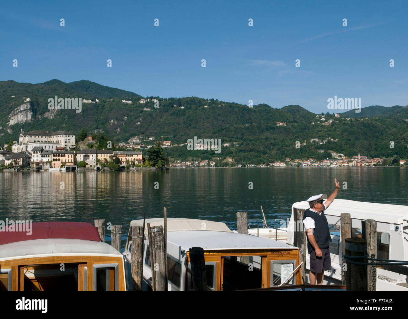 boat captain in Orta San Giulio and San Giulio Island in the background ...