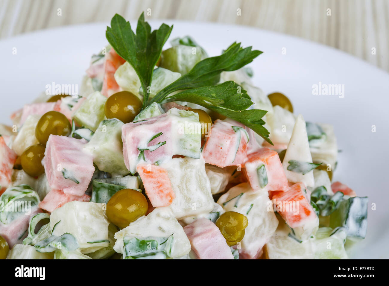 Traditional cuisine - Russian salad with parsley and sausages Stock ...