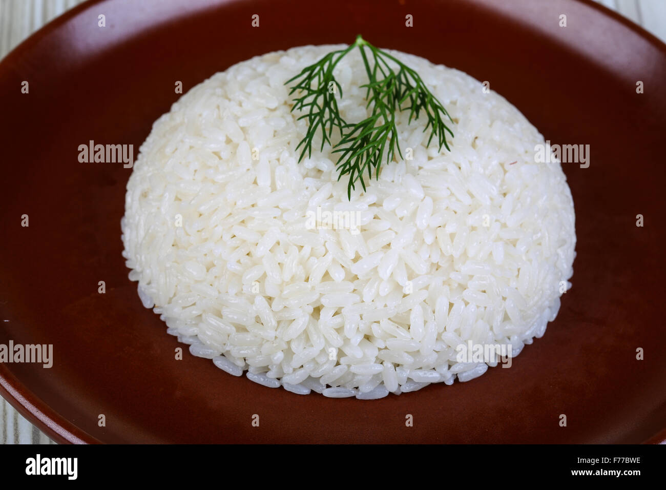 Hot Steamed rice with dill branch on the brown plate Stock Photo - Alamy