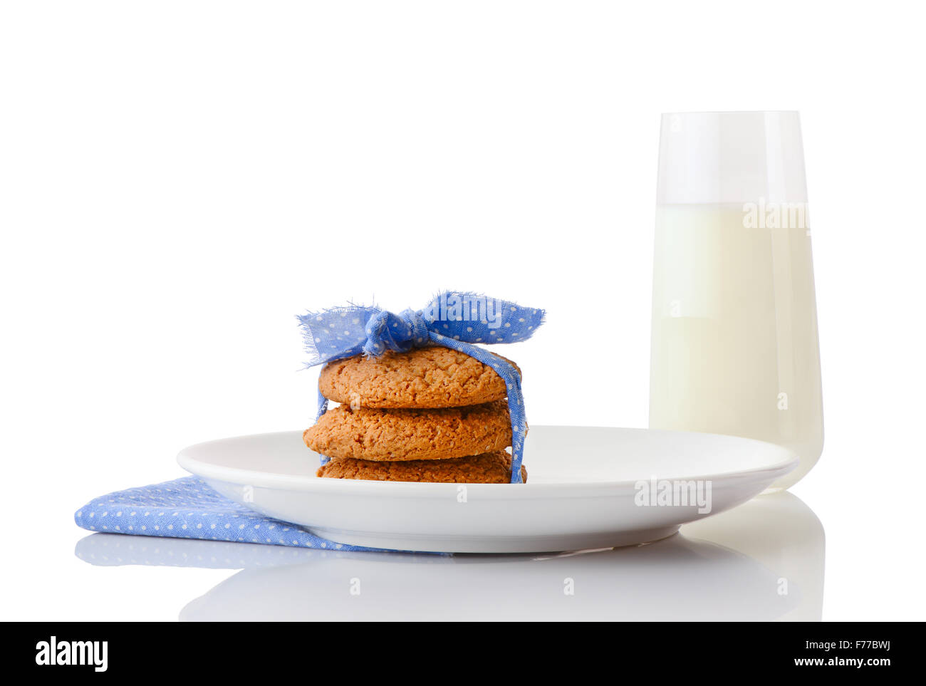 Stack of three homemade oatmeal cookies tied with blue ribbon on white ...