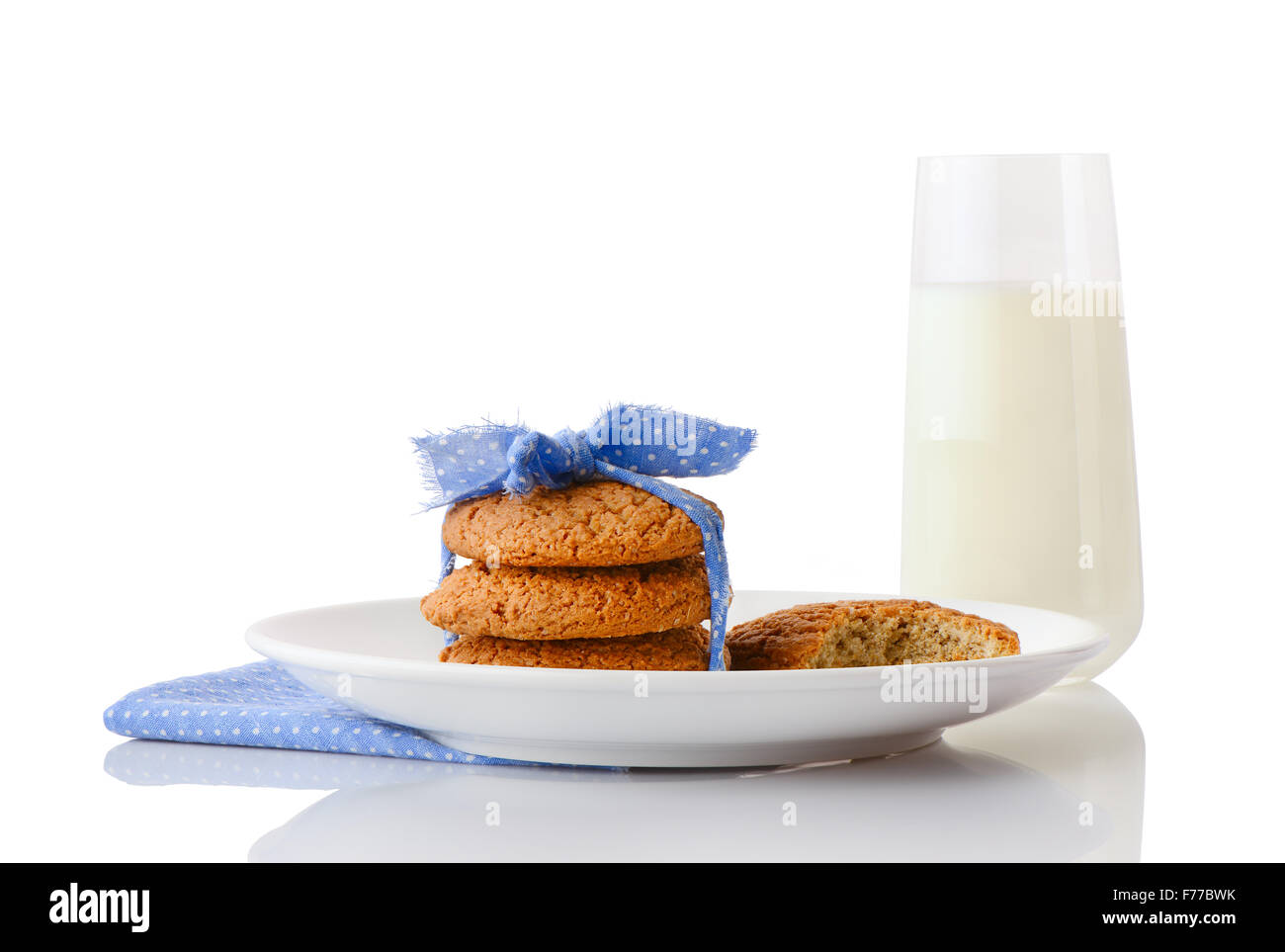 Stack of three homemade oatmeal cookies tied with blue ribbon on white ...
