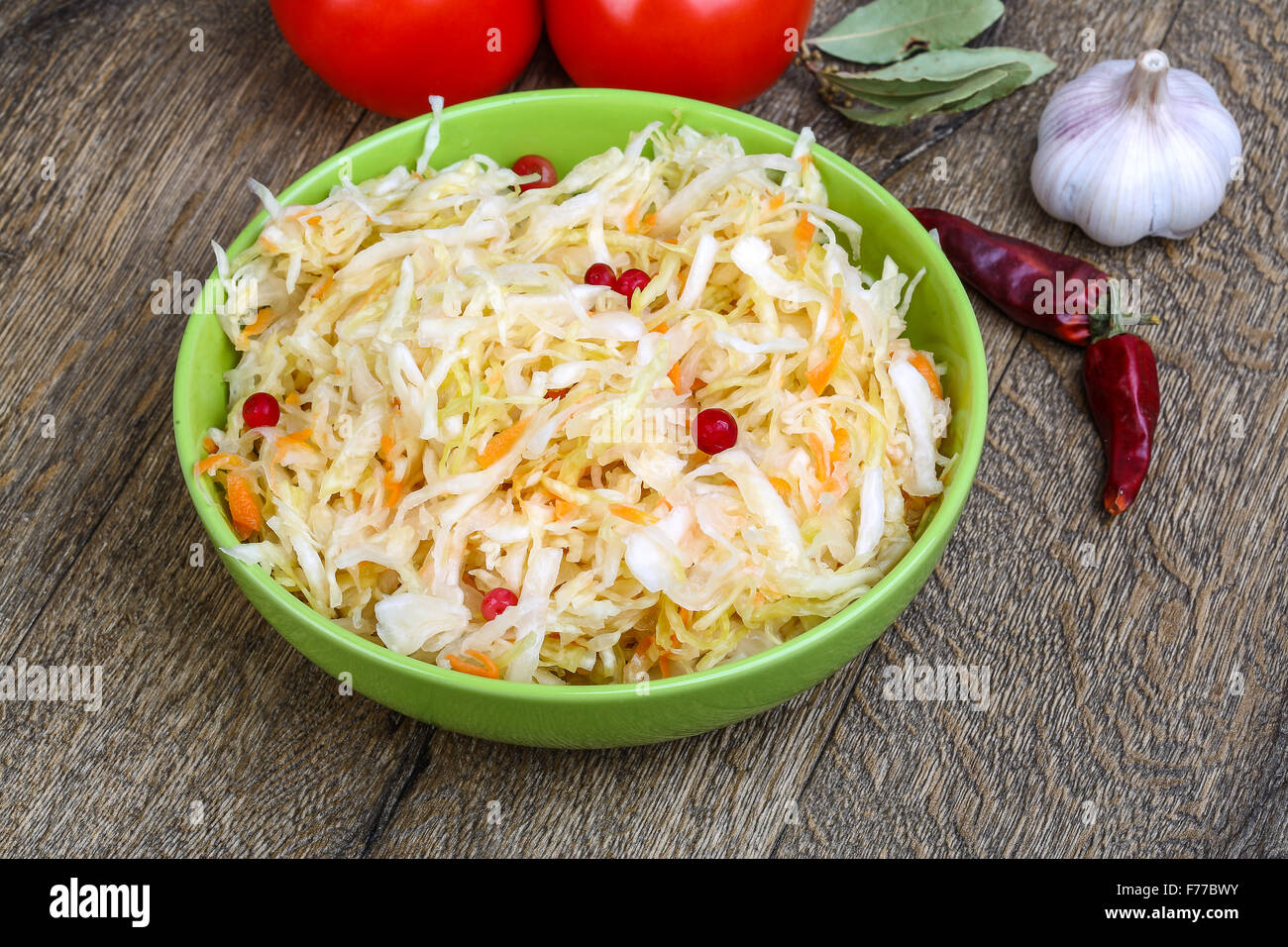 Fermented cabbage - Sauerkraut with herbs and spices on the wood ...
