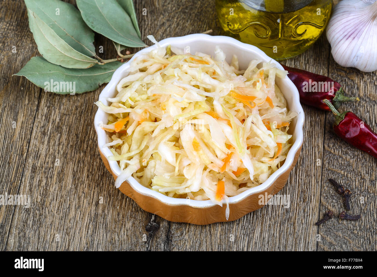 Fermented cabbage - Sauerkraut with herbs and spices on the wood ...