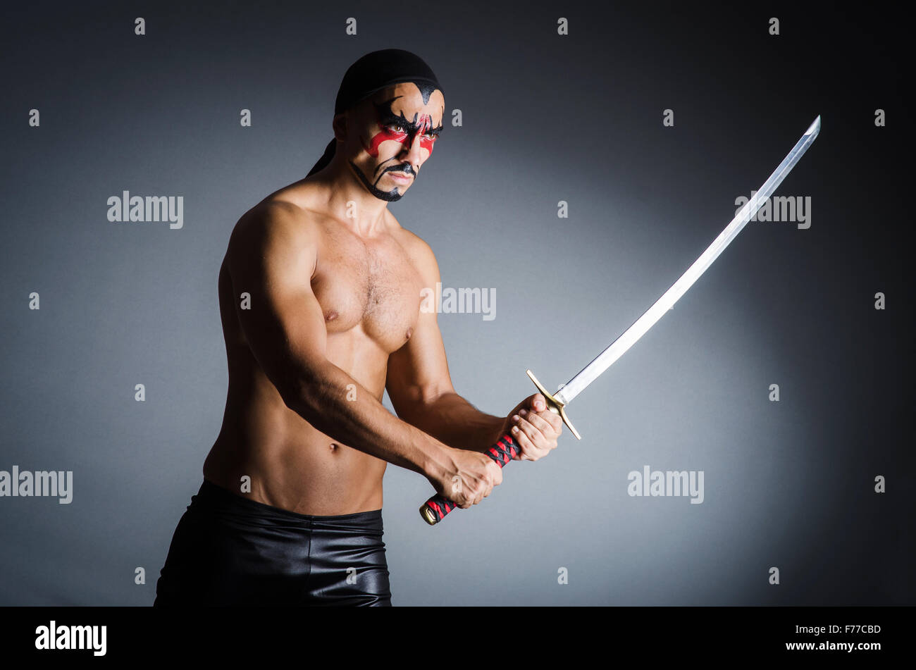Man with sword and face paint Stock Photo - Alamy